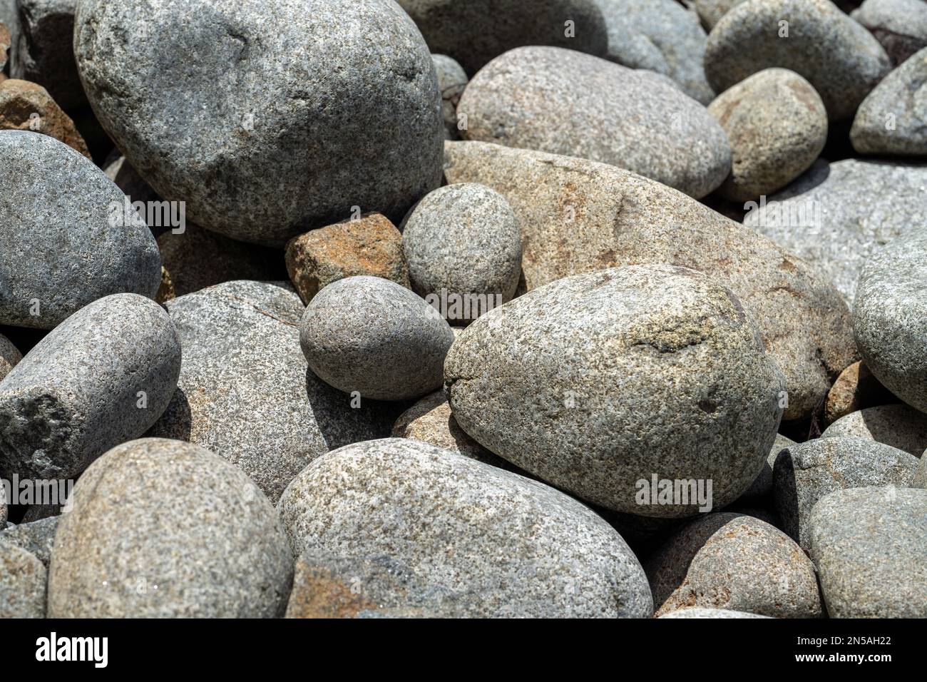 round rocks and pebbles on the beach in australia Stock Photo - Alamy