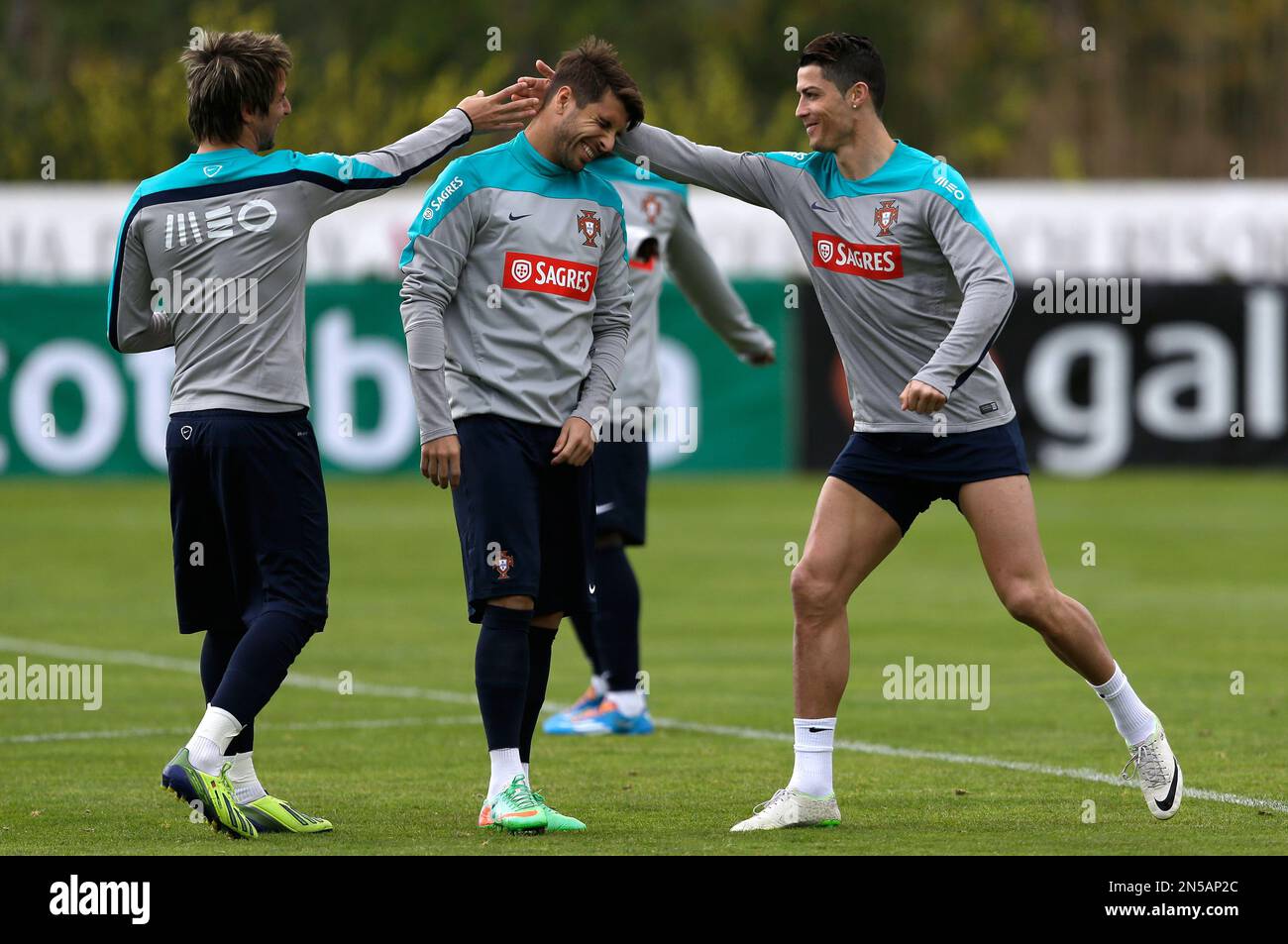 Cristiano Ronaldo, right, and Fabio Coentrao, left, joke with teammate ...