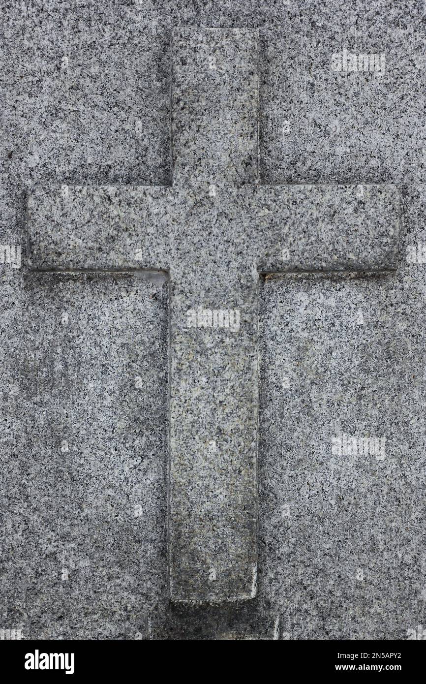 Simple vintage Christian cross standing high on a tombstone in the ...
