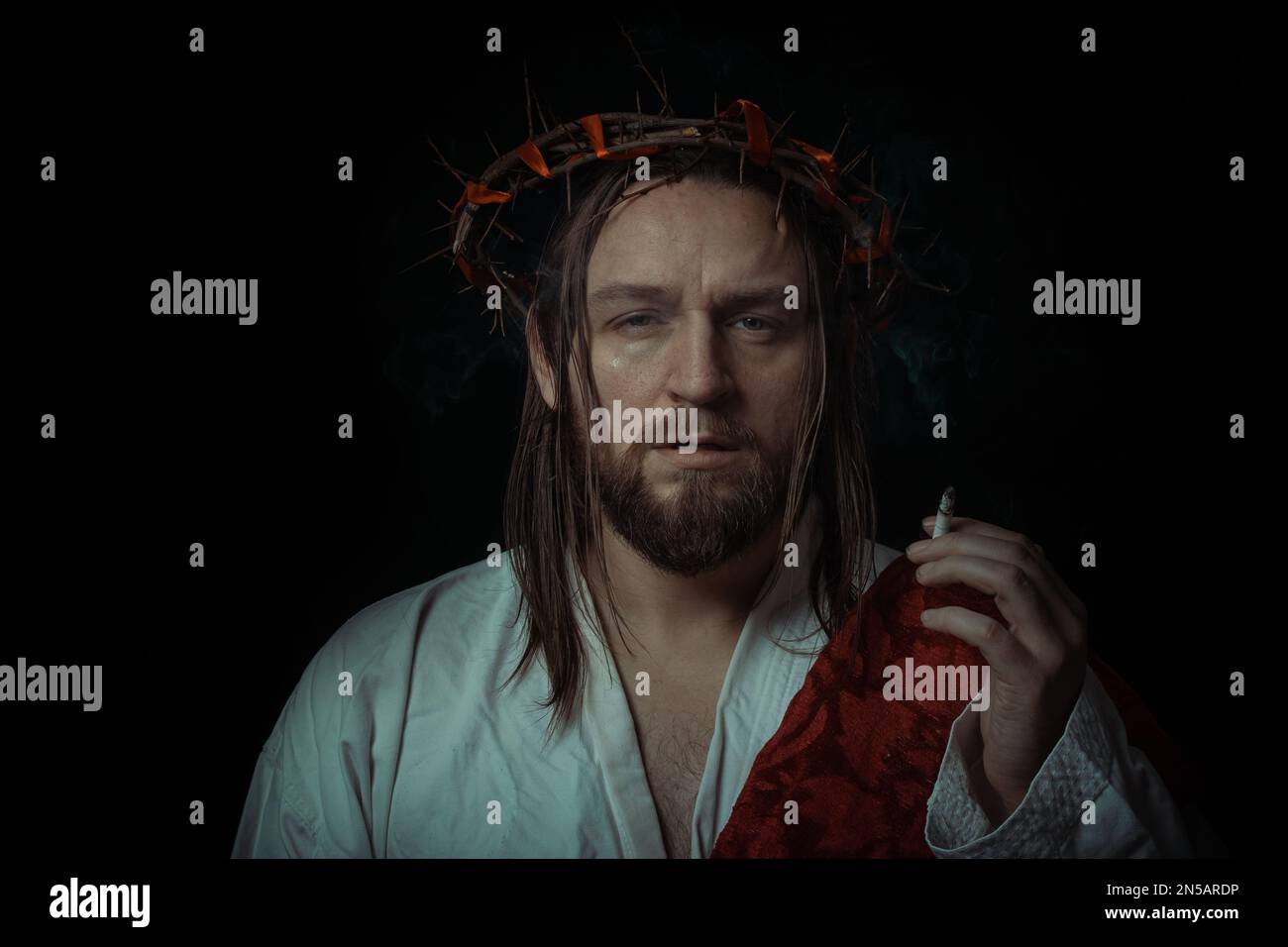Jesus Christ smokes a cigarette wearing a crown of thorns and white ...