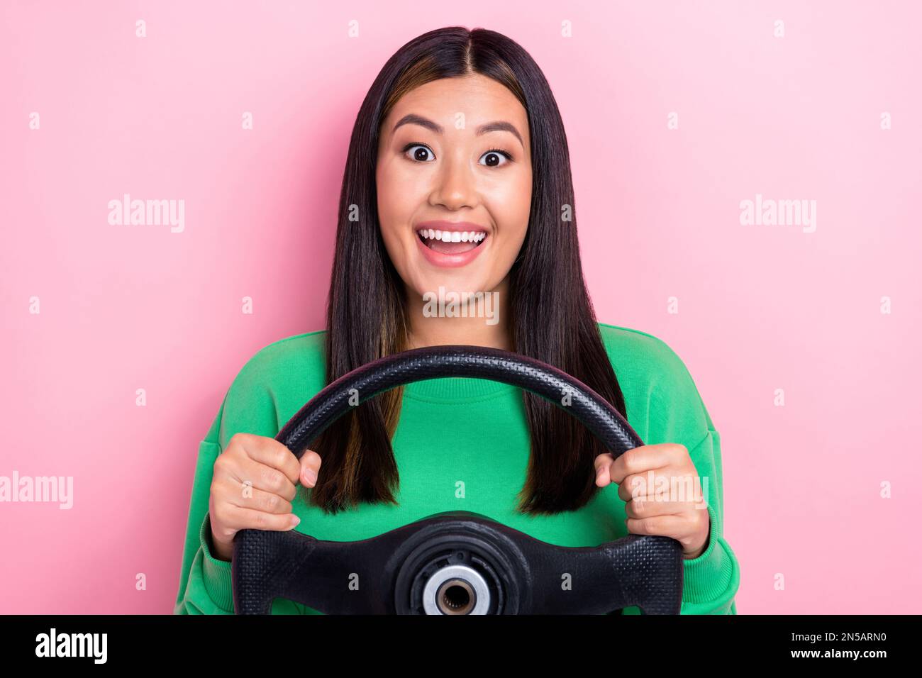Photo of young overjoyed excited junior car driver lady hold steering ...