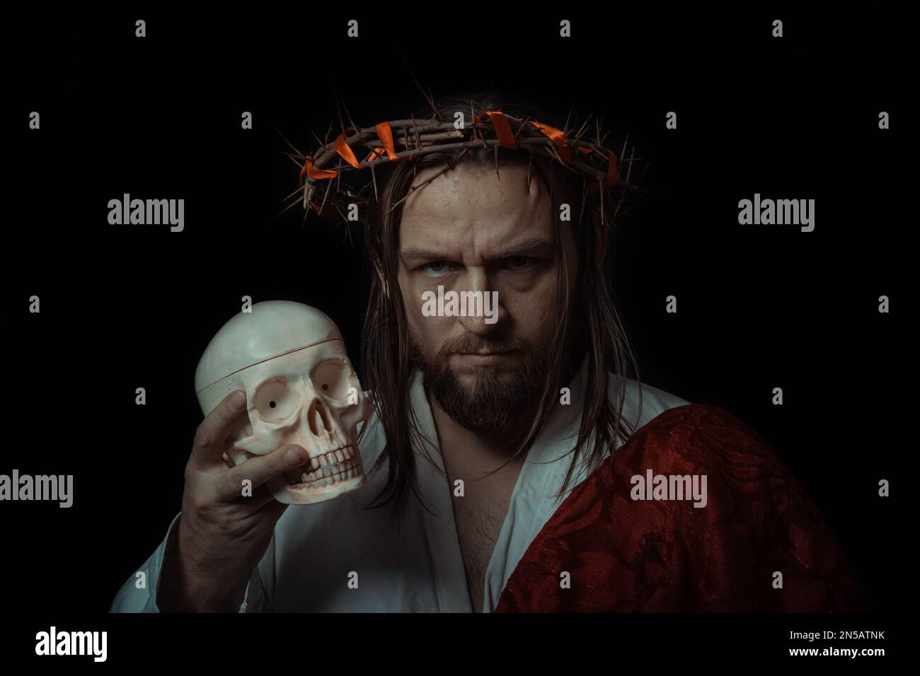 Jesus Christ with skull wearing a crown of thorns and white chiton toga ...