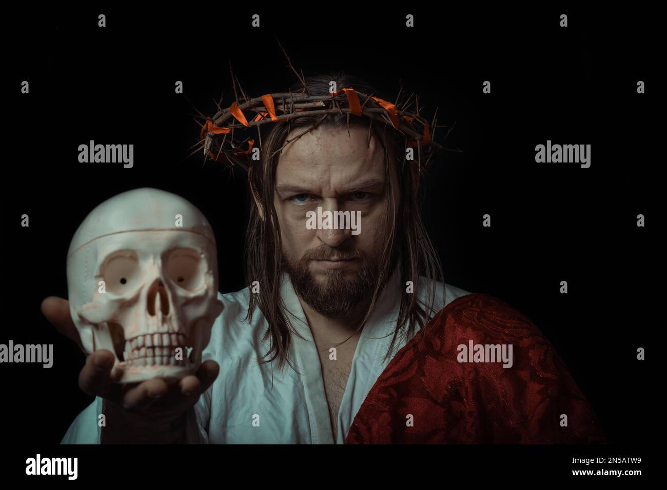 Jesus Christ with skull wearing a crown of thorns and white chiton toga ...