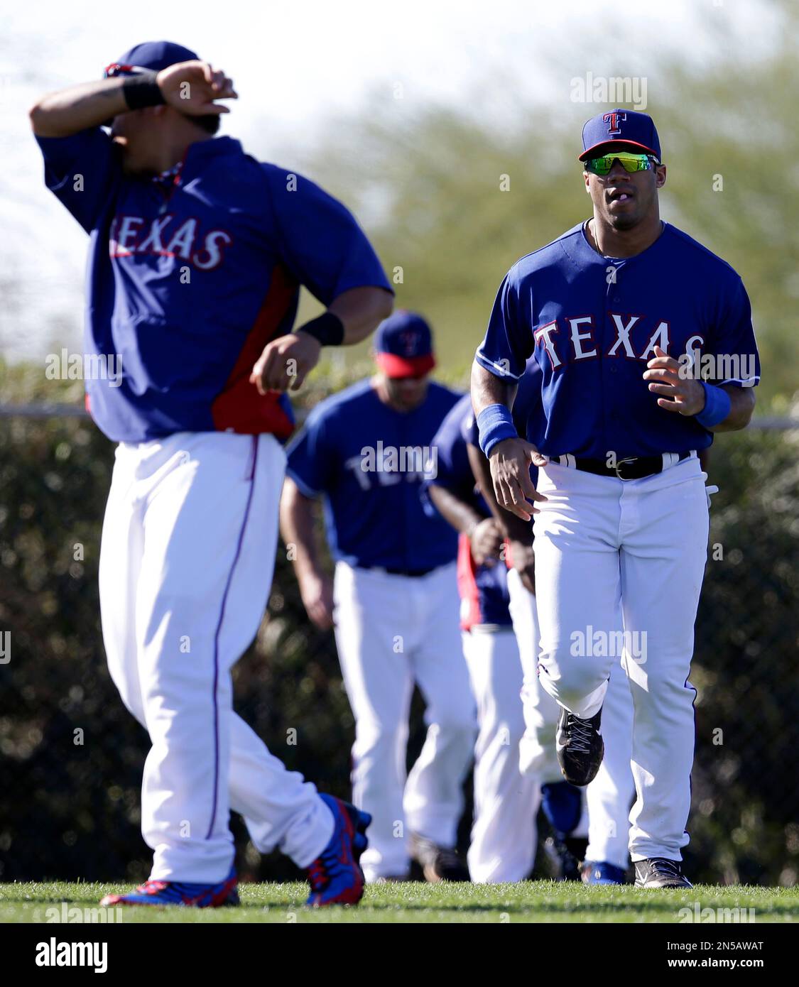 Seattle Seahawks quarterback Russell Wilson, right, runs through warm ...