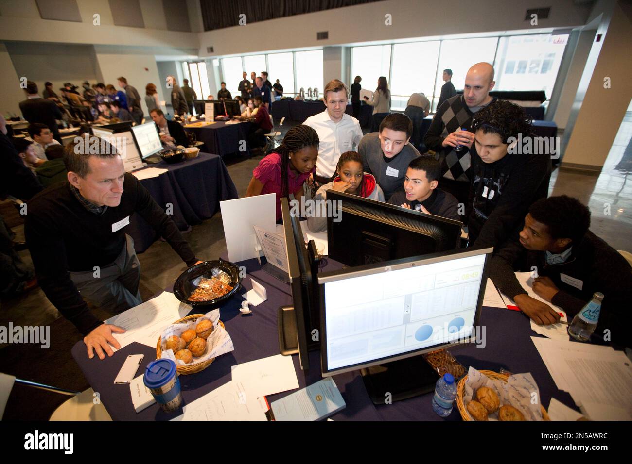 Magnetar CEO Alec Litowitz, left, checks a computer as Sullivan High ...