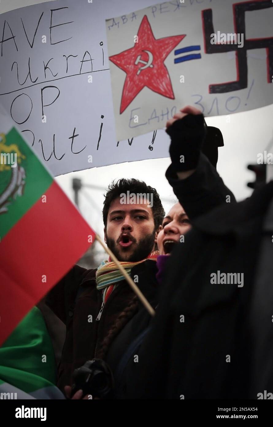 Bulgarian protesters shout anti-Russian slogans and hold a poster ...