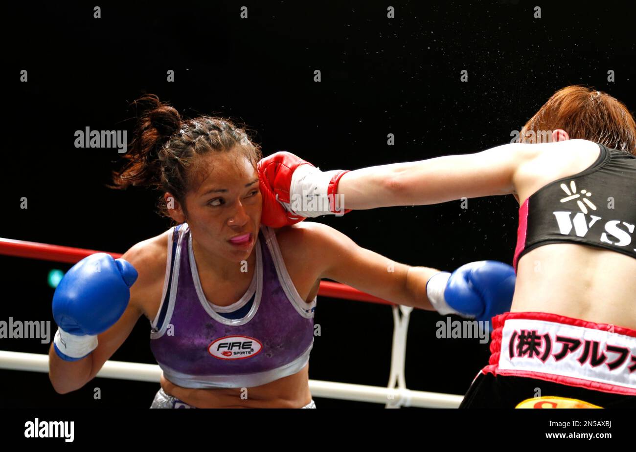 Mexican challenger Guadalupe Martinez, left, gets a punch from Japanese ...
