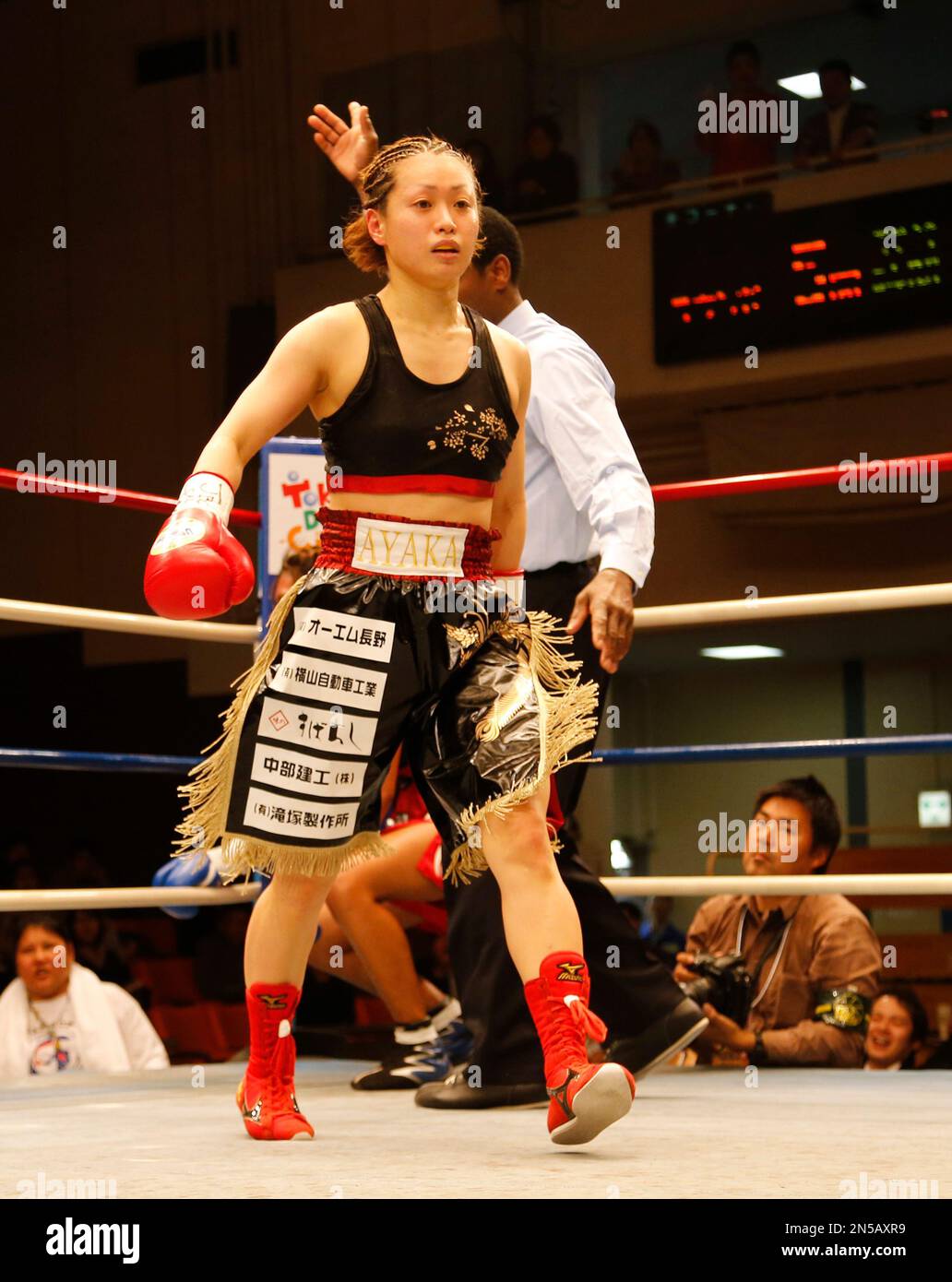 Japanese champion Ayaka Miyao returns to her corner after knocking down Thai challenger Buangern ...