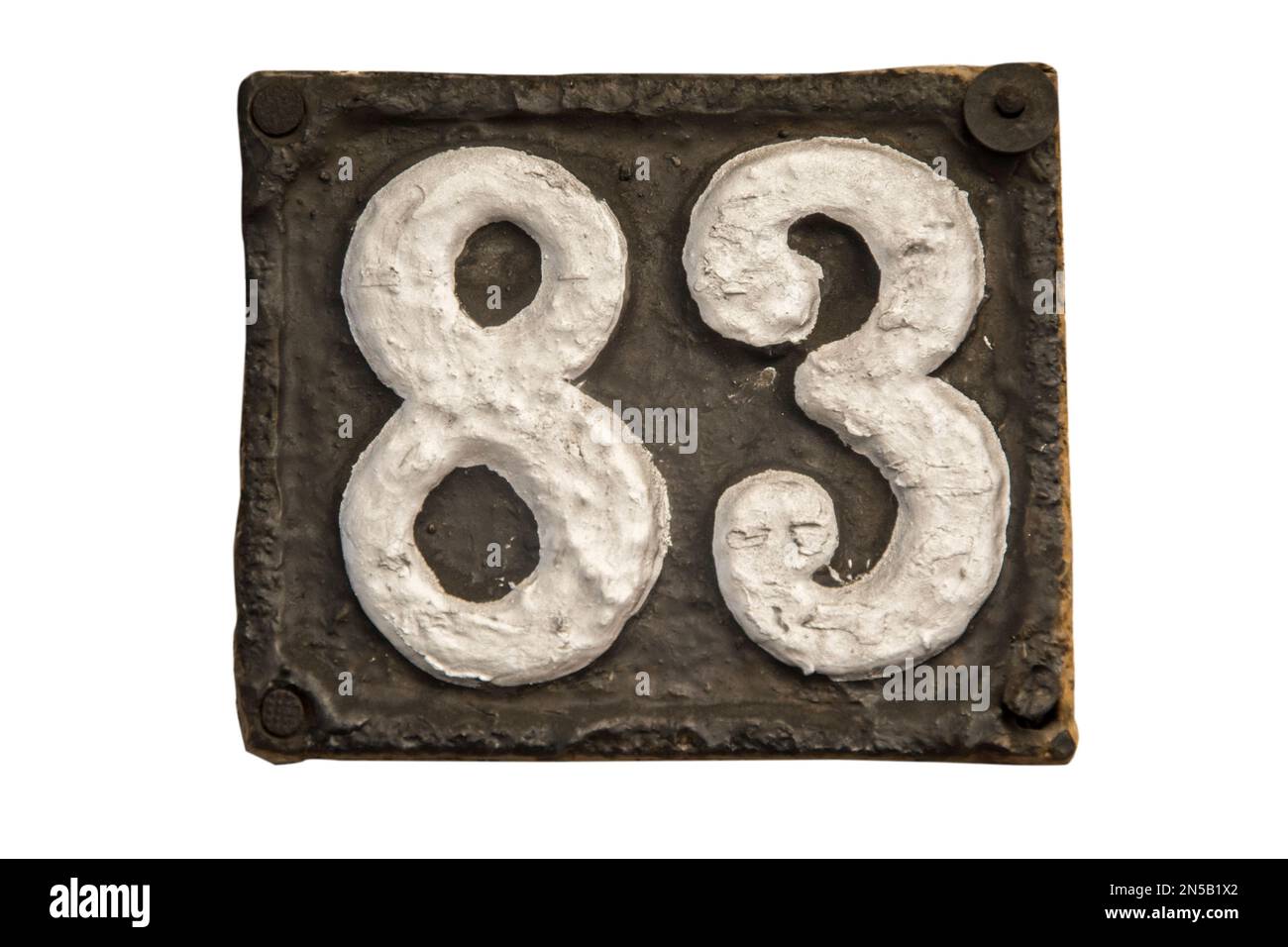 Old retro weathered cast iron plate with number 83 closeup isolated on ...