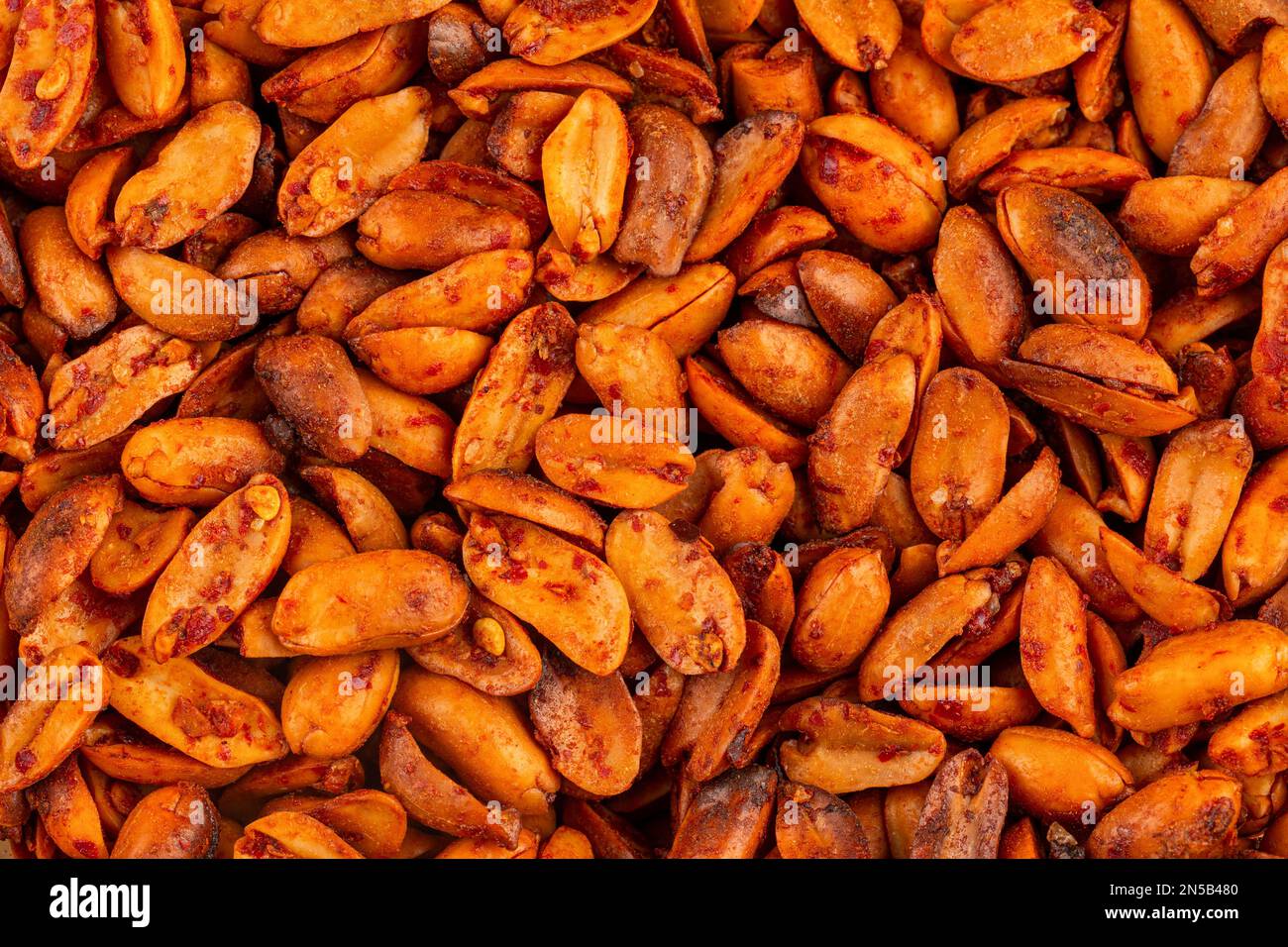 Spicy peanuts snack with hot pepper macro. Nuts with spices appetizer ...