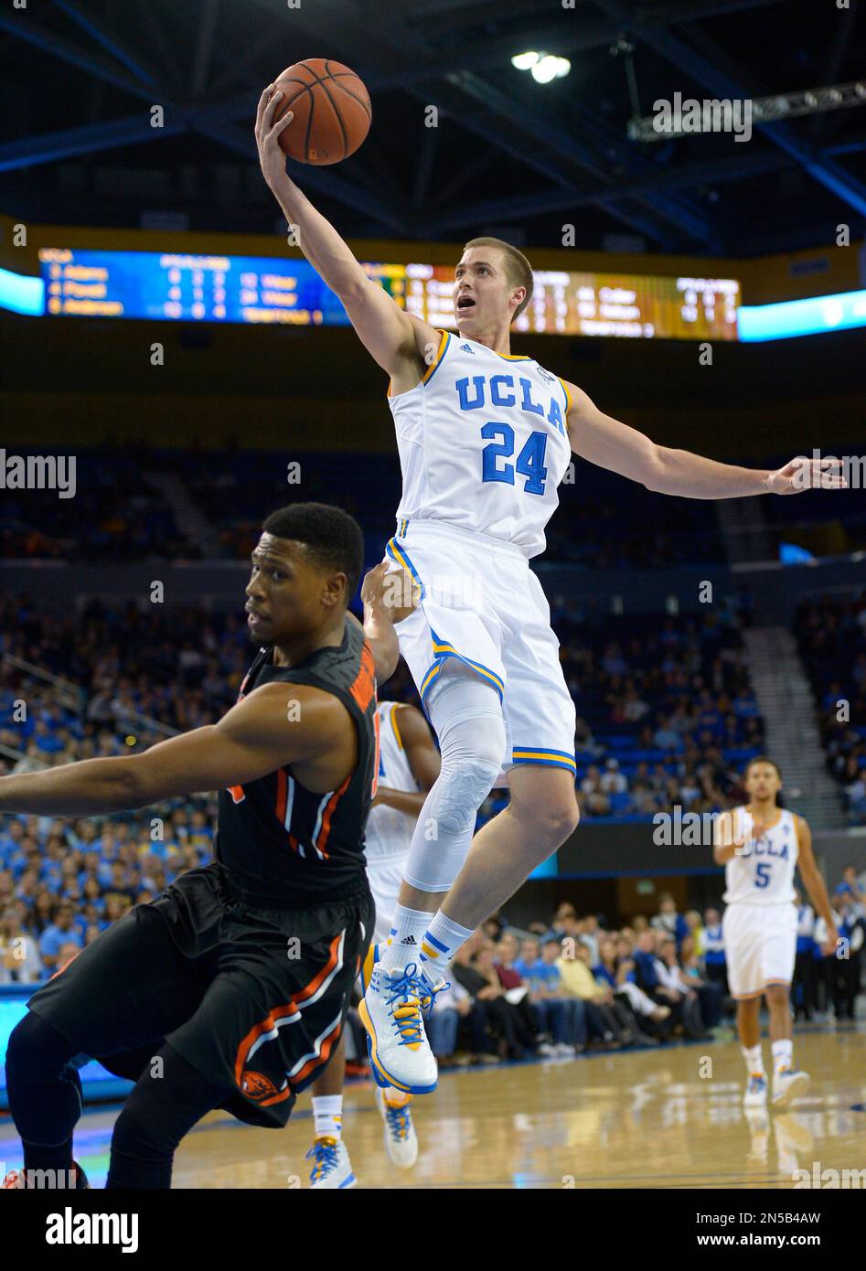 UCLA forward Travis Wear shoots as Oregon State guard Langston Morris ...