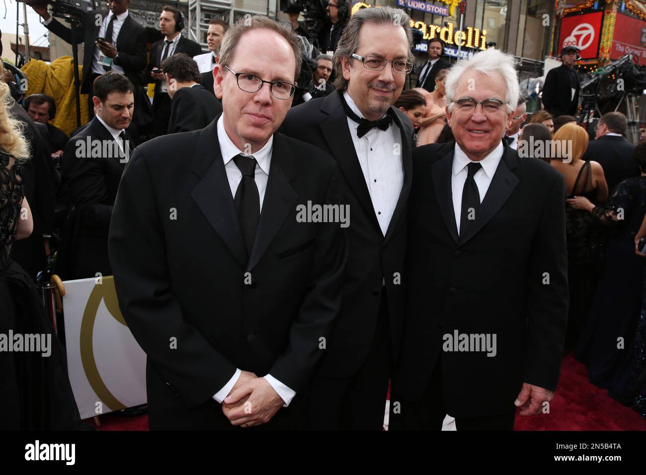 From left, Albert Berger, Bob Nelson and Ron Yerxa arrive at the Oscars ...