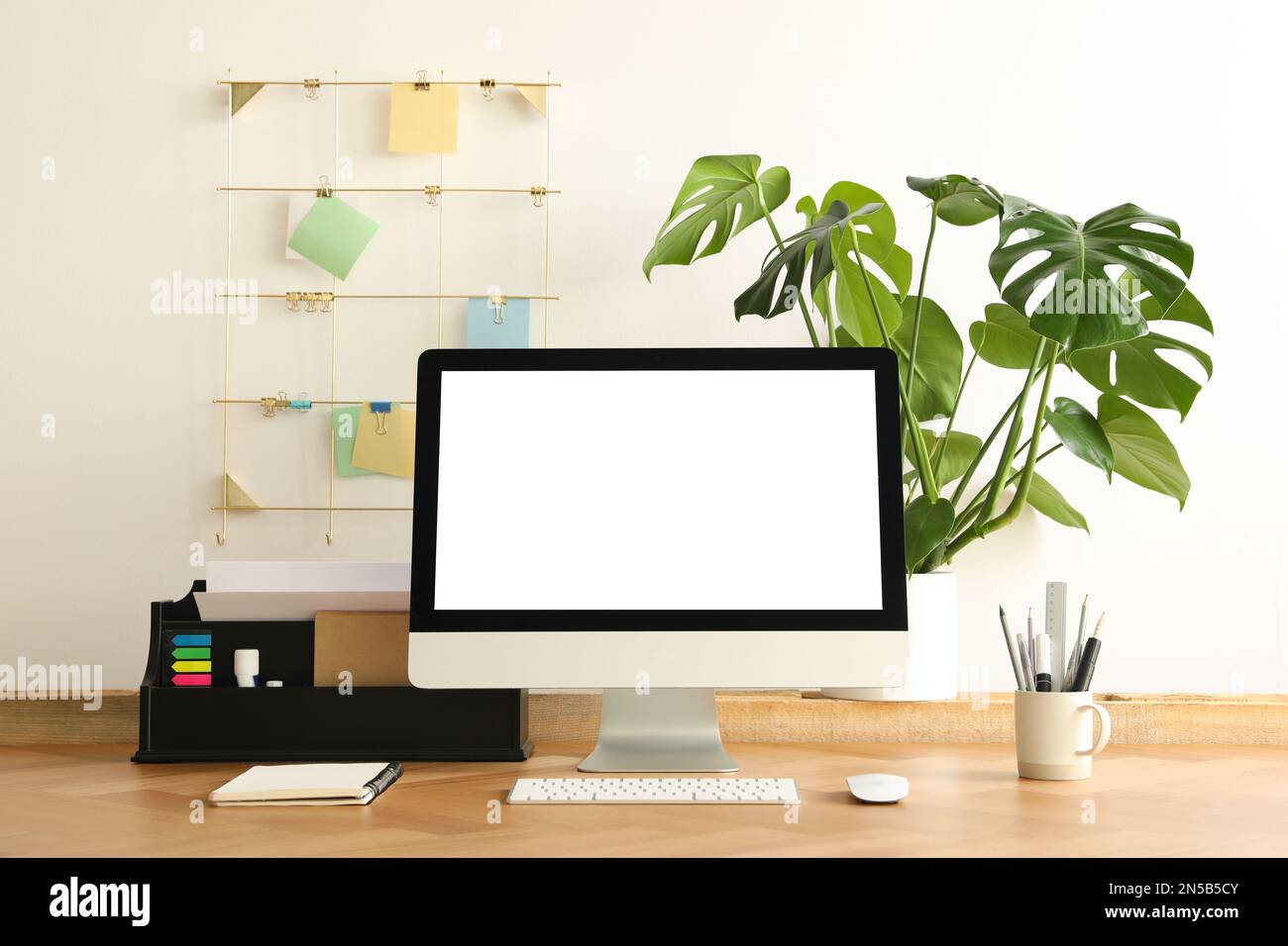 Comfortable workplace with modern computer near on table near white ...