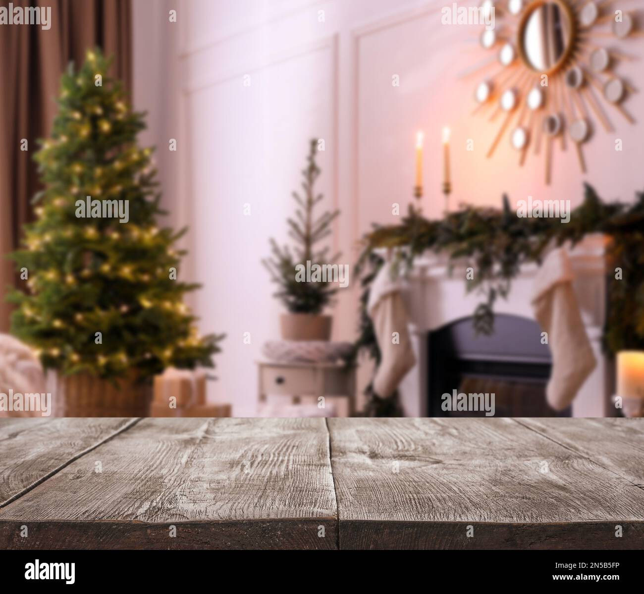 Empty wooden surface and blurred view of room decorated for Christmas ...
