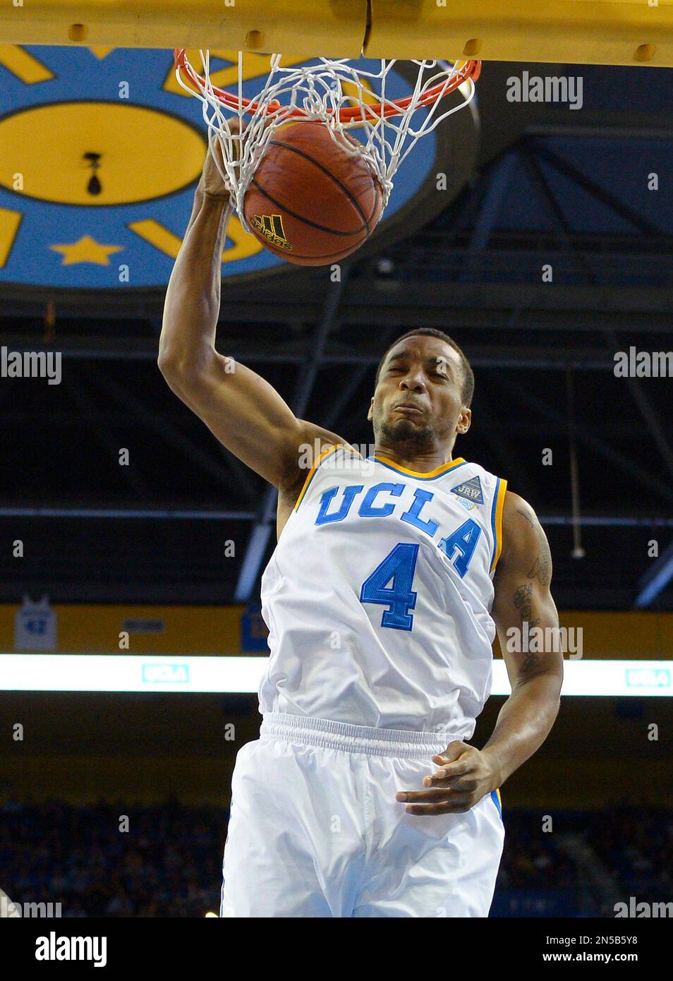 UCLA guard Norman Powell dunks during the first half of an NCAA college ...