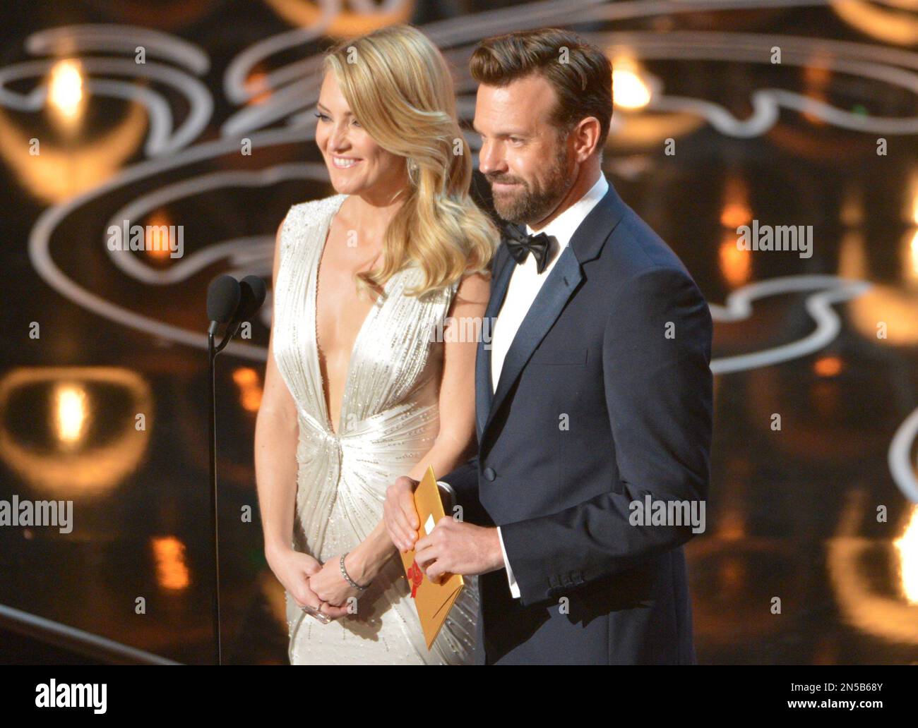 Kate Hudson, left, and Jason Sudeikis speak during the Oscars at the ...