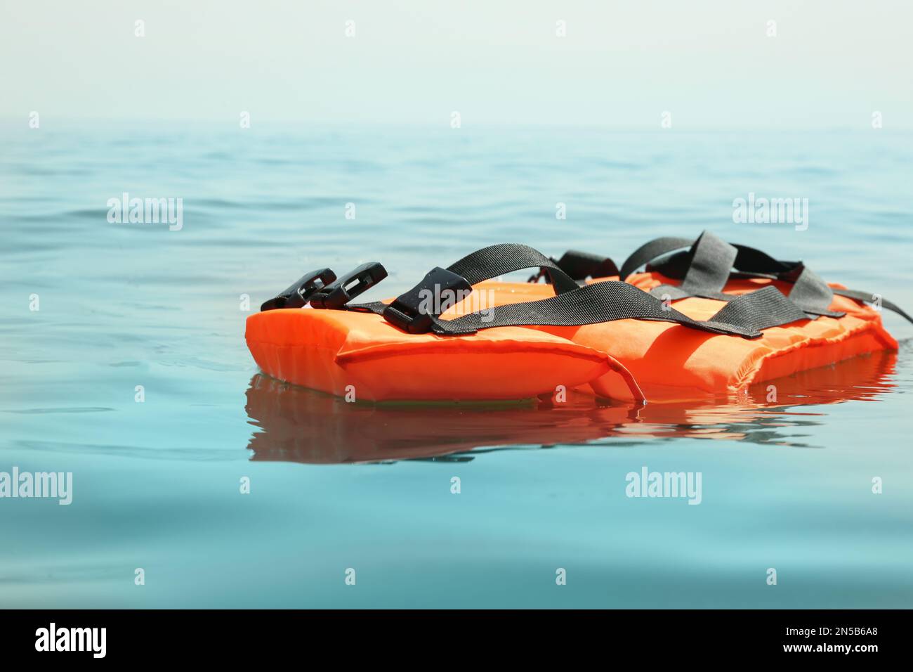 Orange life jacket floating in sea. Emergency rescue equipment Stock ...