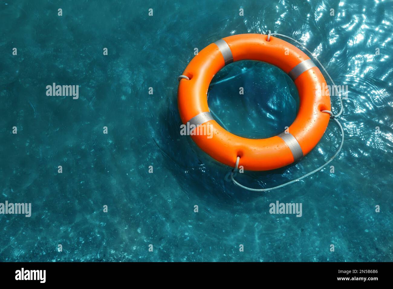 Orange life buoy floating in sea, above view. Emergency rescue ...