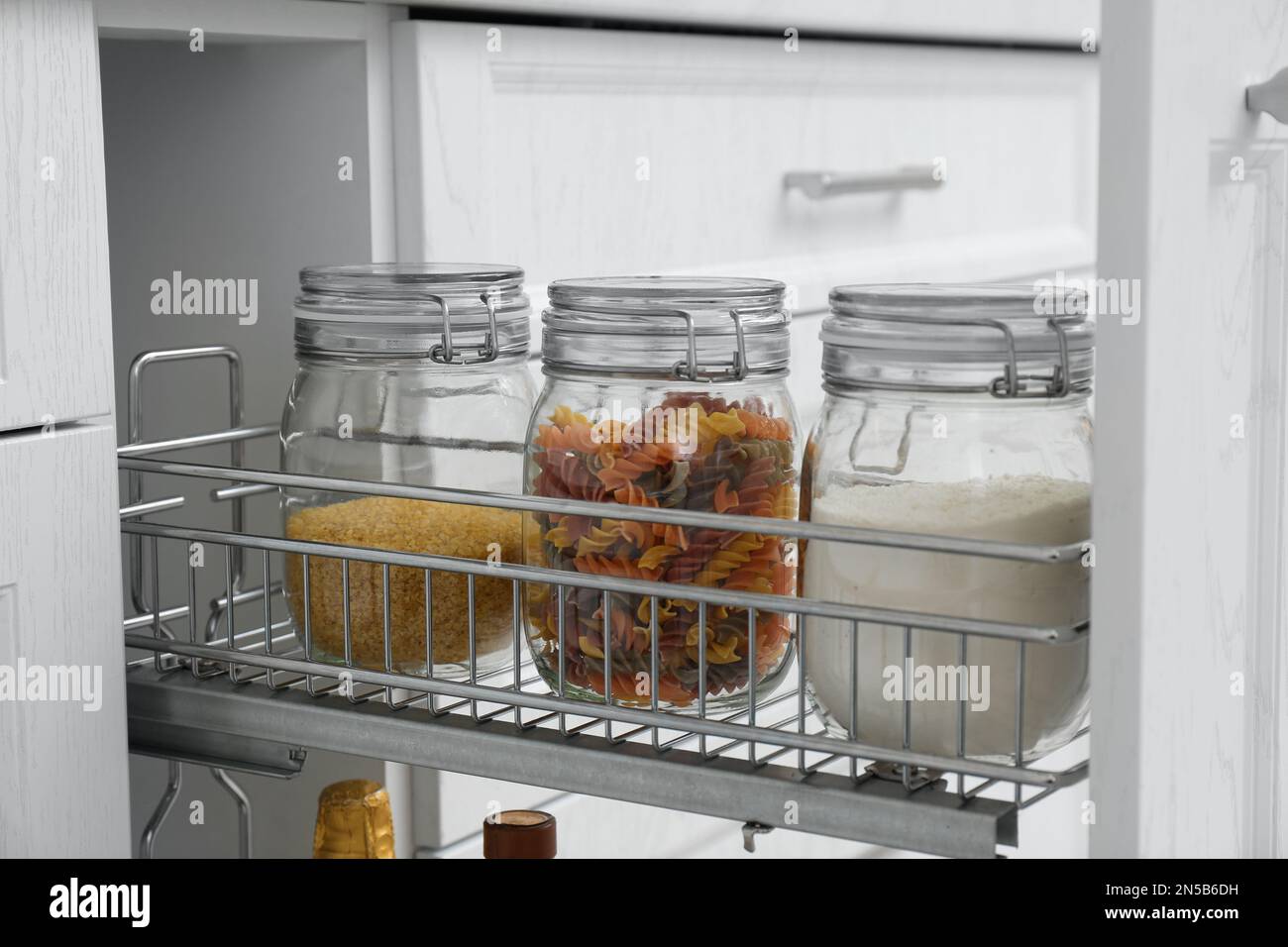 Open drawer with jars of food in kitchen Stock Photo - Alamy