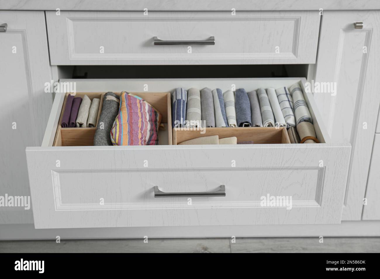 Open drawer with different textiles in kitchen Stock Photo - Alamy