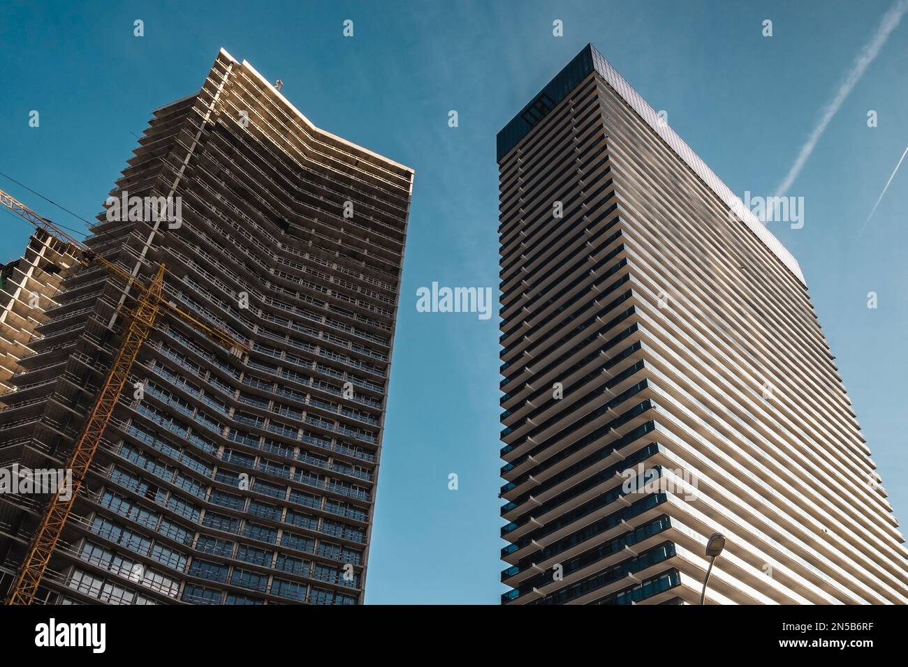 Residential buildings construction site with cranes. New build ...