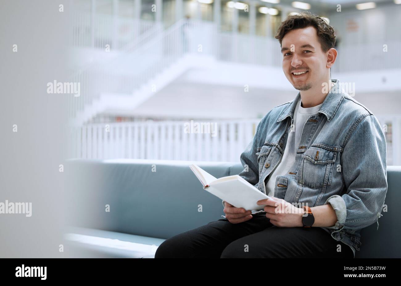 Reading, books and happy man in library for university, college or ...