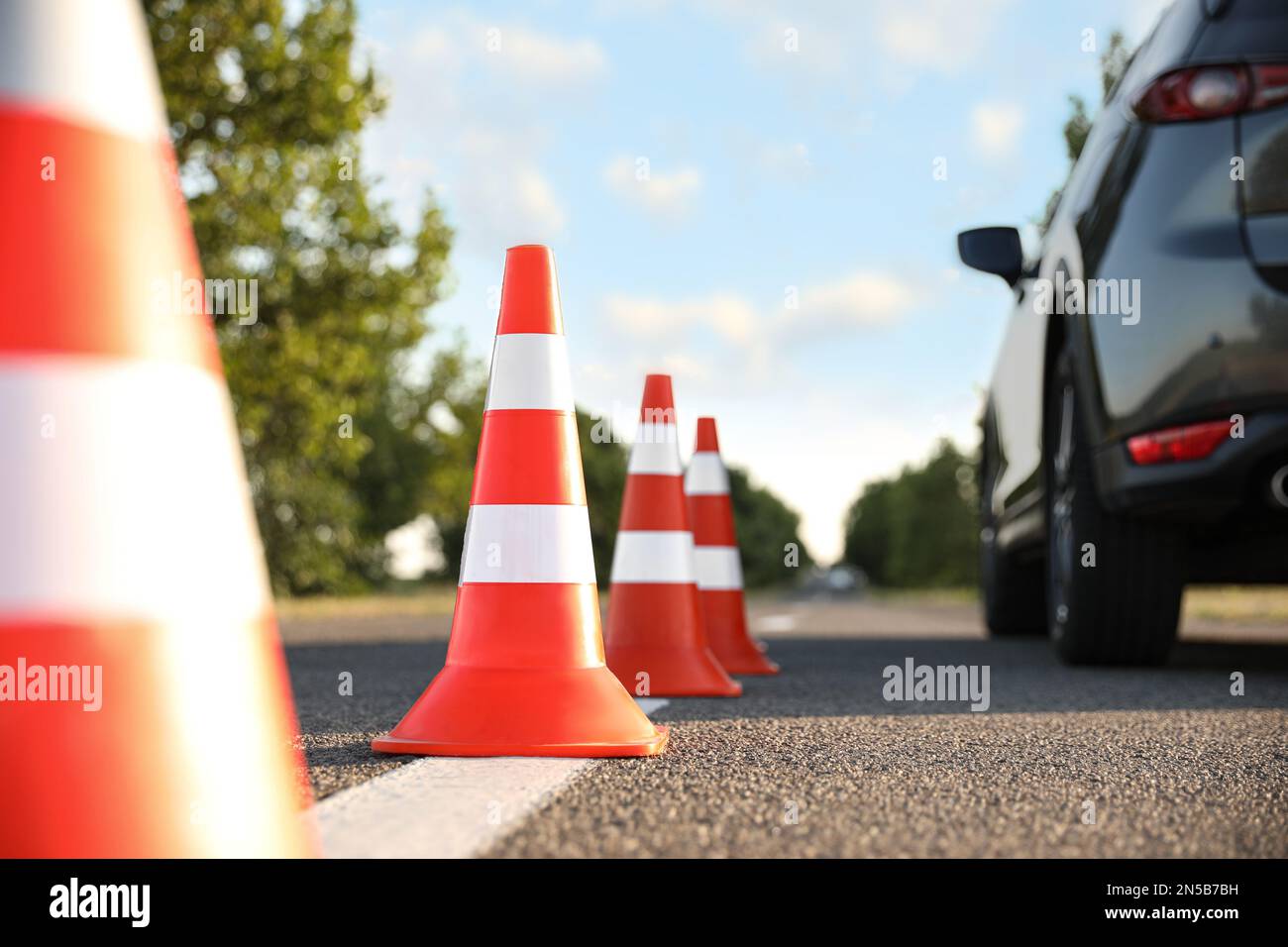 Traffic cones near car outdoors. Driving school exam Stock Photo - Alamy