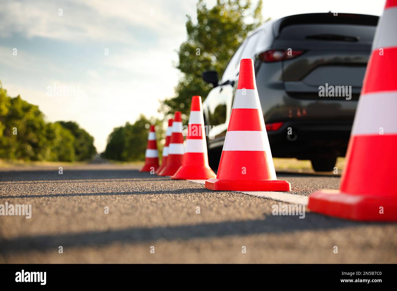 Traffic cones near car outdoors. Driving school exam Stock Photo - Alamy