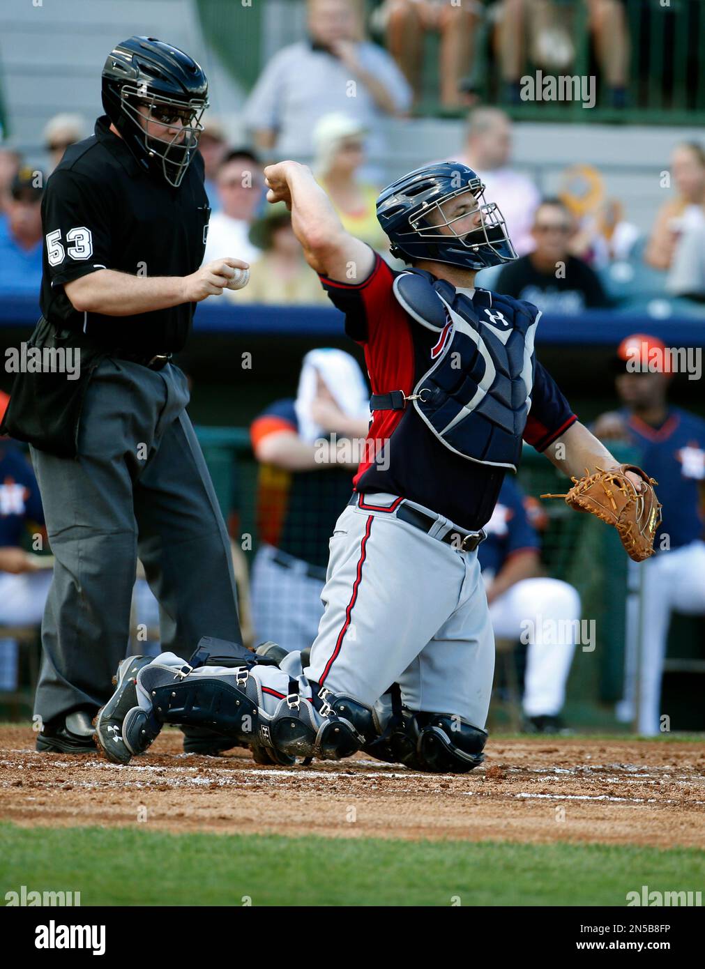 Atlanta Braves catcher Evan Gattis (24) throws the ball back, with ...