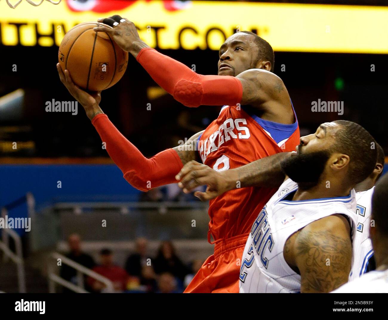 Philadelphia 76ers' Tony Wroten, top, goes to the basket past Orlando ...