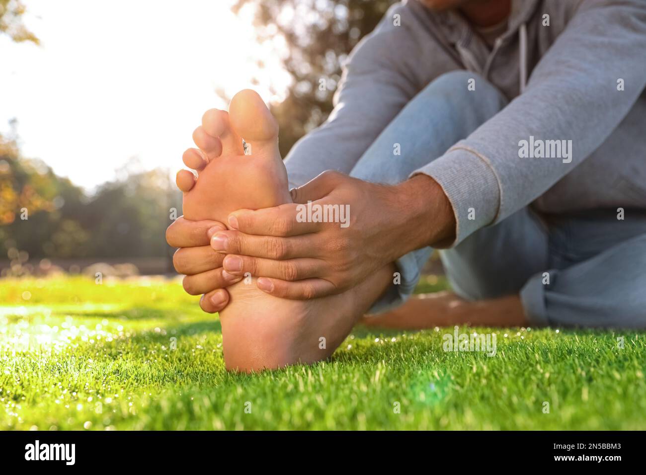 Man sitting barefoot hi-res stock photography and images - Alamy