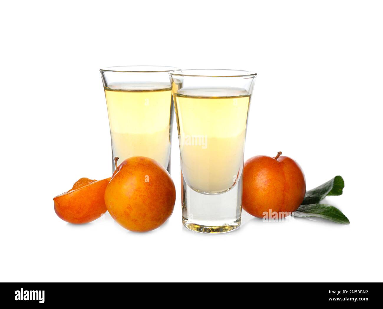 Delicious plum liquor and ripe fruits on white background. Homemade ...