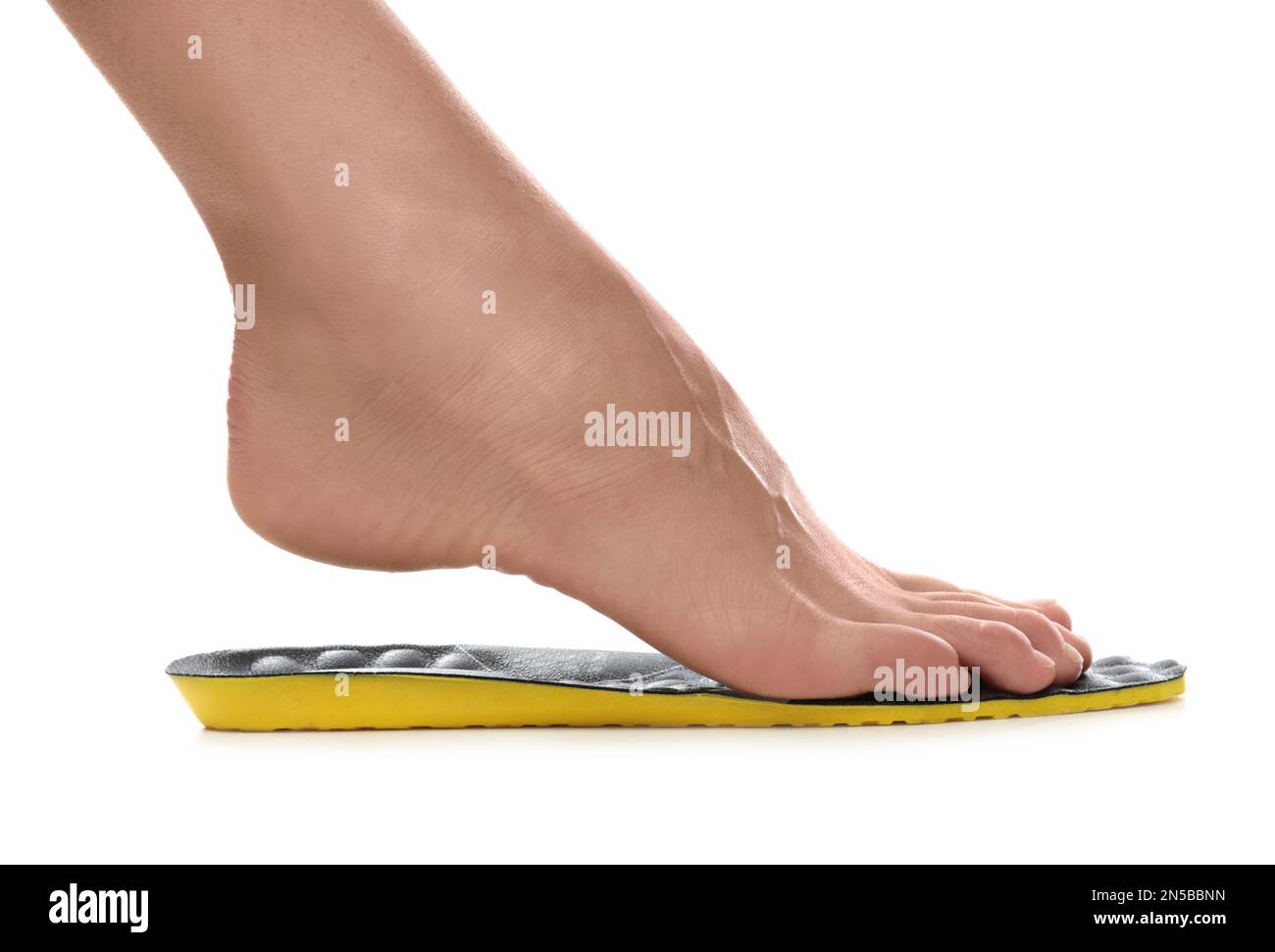 Woman fitting orthopedic insole on white background, closeup. Foot care ...