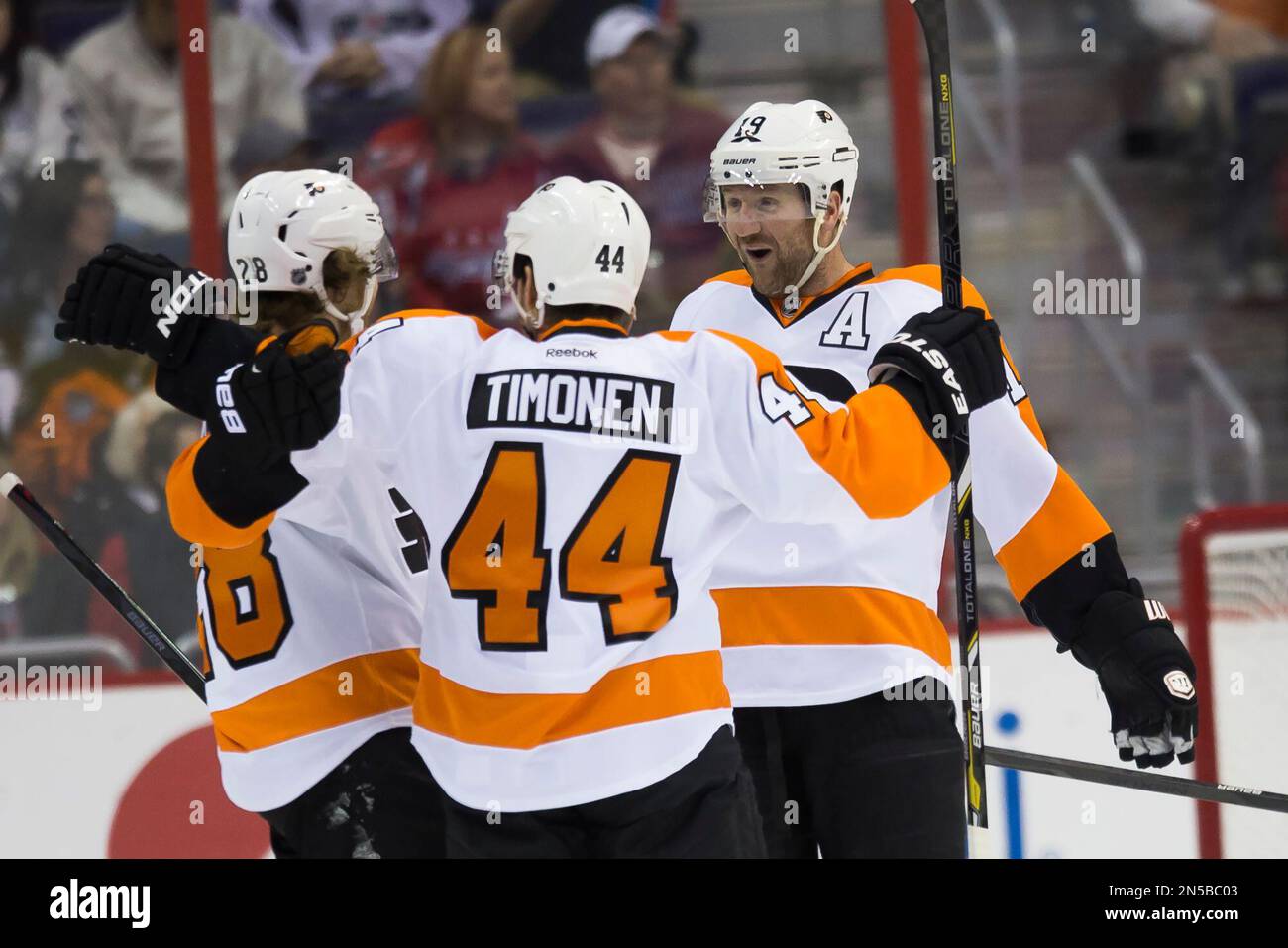 Philadelphia Flyers center Claude Giroux, left, celebrates his first ...