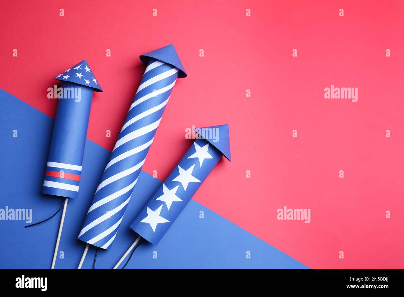 Firework rockets on color background, flat lay. Space for text Stock ...