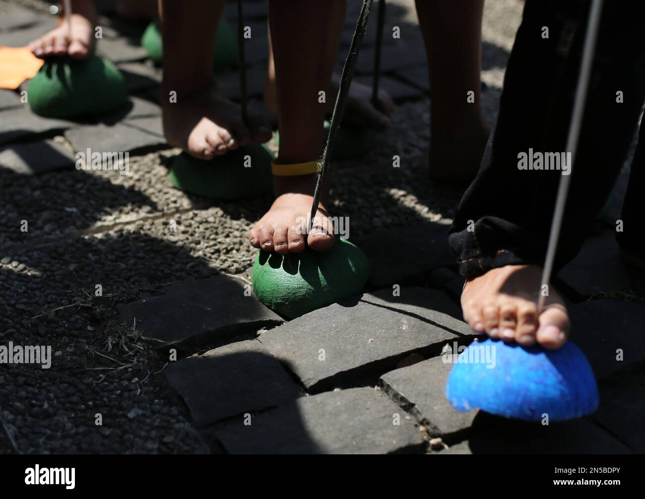 Filipino children use coconut husks as stilt-like footwear, locally ...