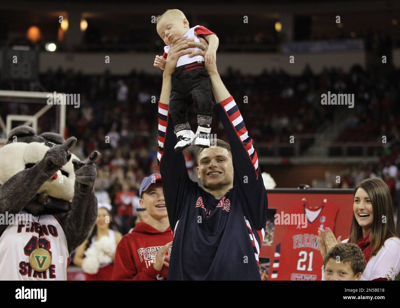 CORRECTS SONS NAME TO DAMEON- Fresno State's Tyler Johnson holds his ...