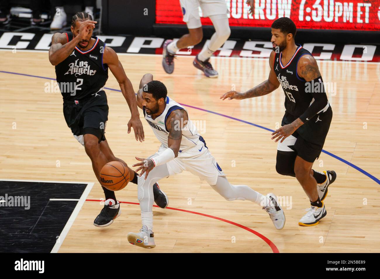 Kyrie Irving (C) of Dallas Mavericks, Kawhi Leonard (L) and Paul George ...