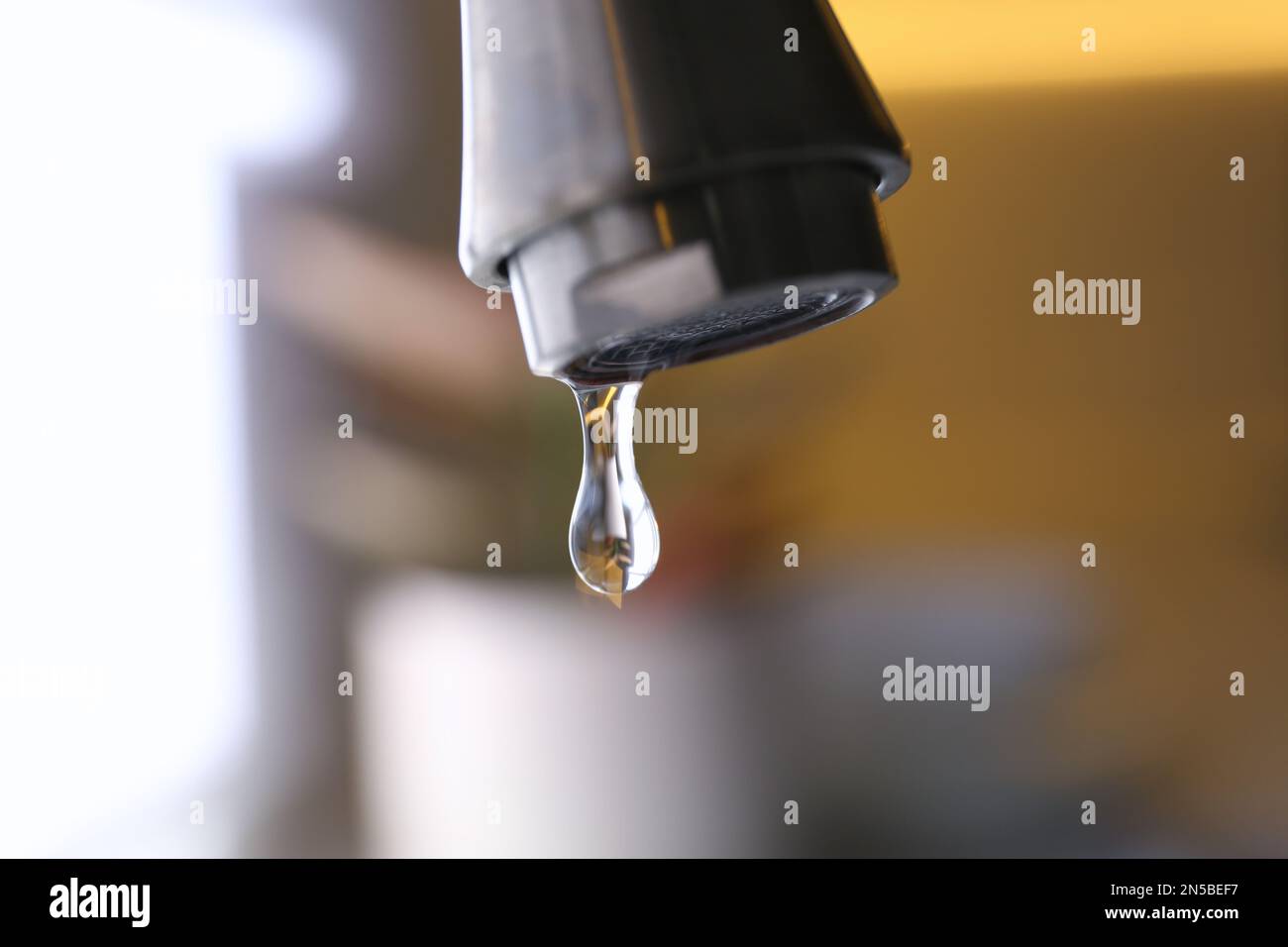 Water drop falling down from tap on blurred background, closeup Stock ...