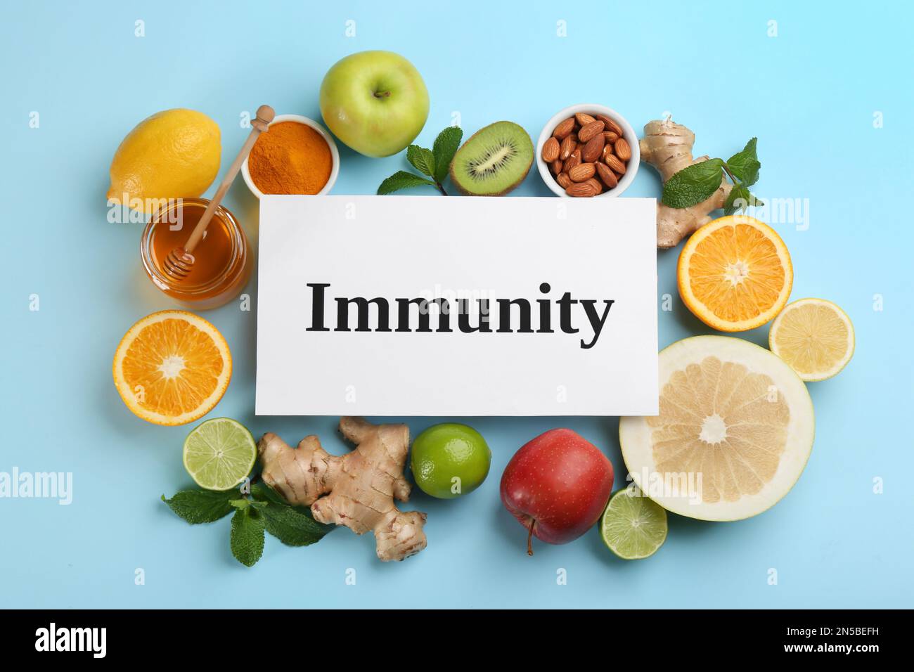Set of natural products and card with word Immunity on light blue ...