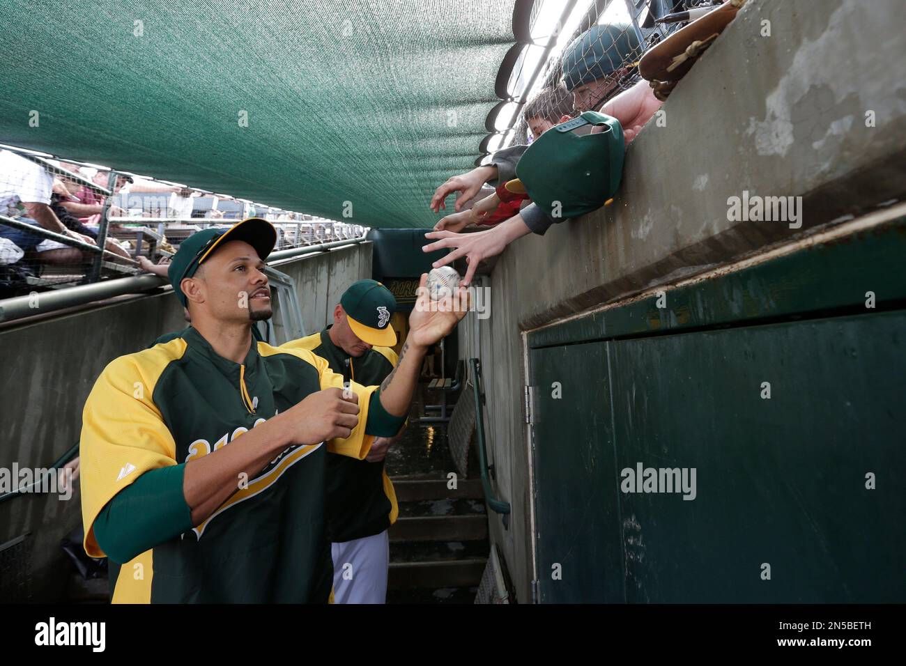 Oakland Athletics center fielder Coco Crisp signs autographs before ...