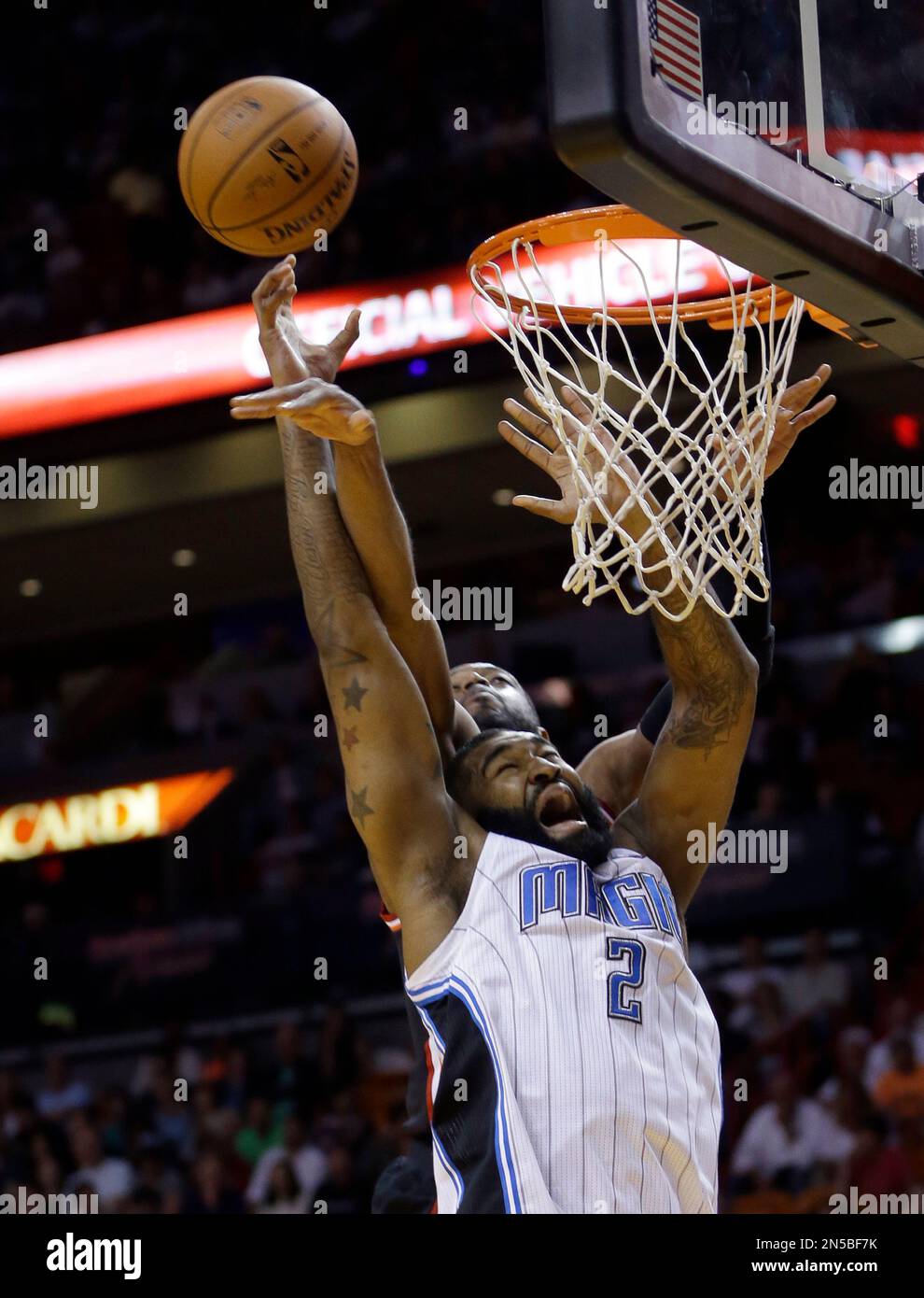 Miami Heat shooting guard Dwyane Wade, background, deflects a shot by ...