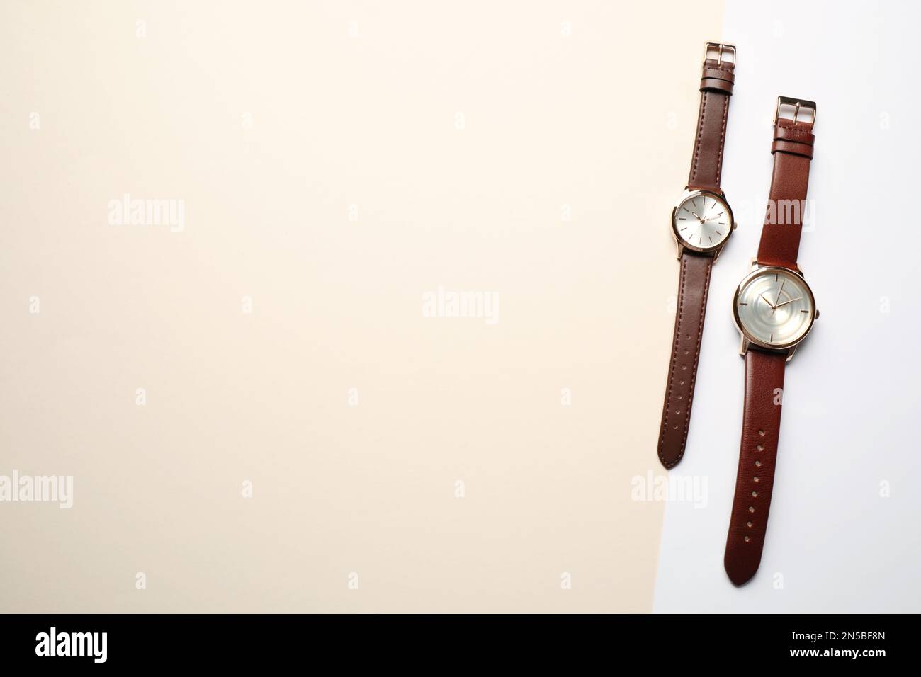 Luxury wrist watches on color background, flat lay. Space for text ...