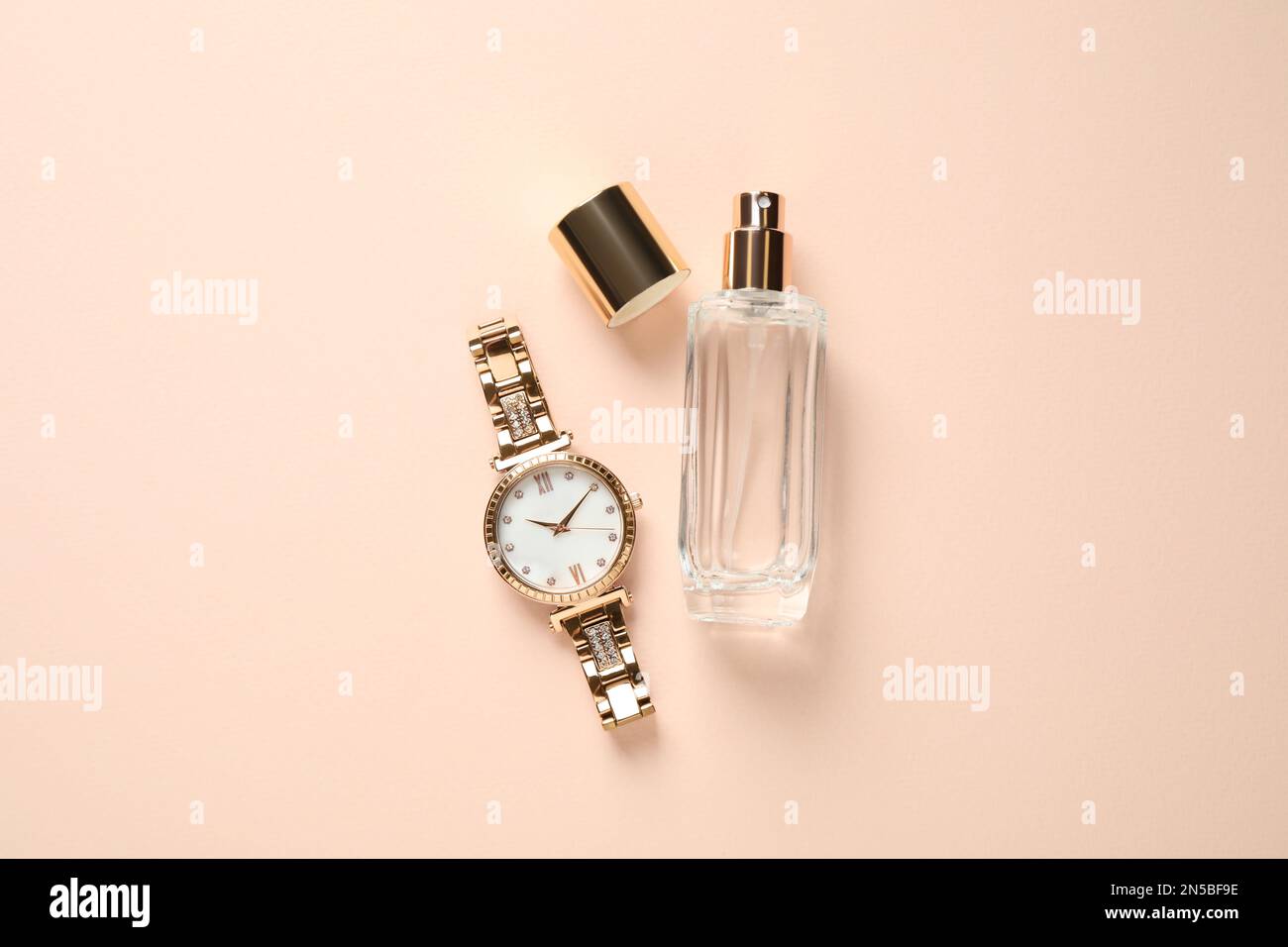 Luxury wrist watch and perfume on beige background, flat lay Stock ...