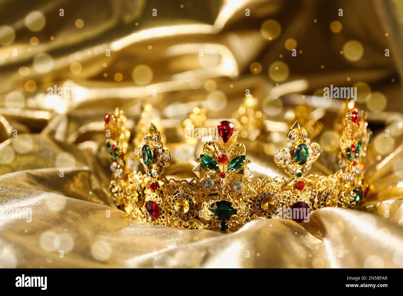Beautiful ancient crown on golden fabric, closeup. Fantasy item Stock ...