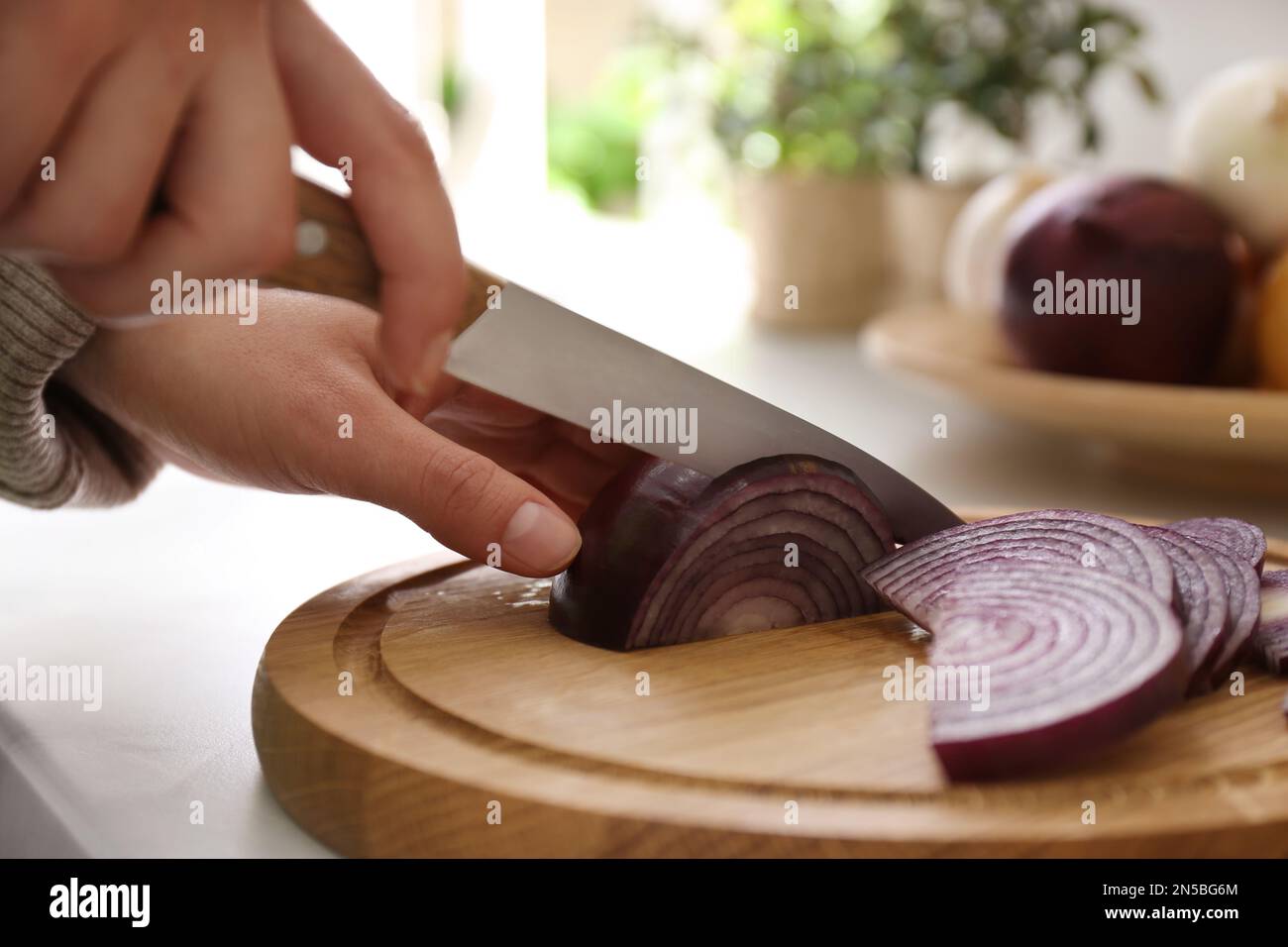 Young woman cutting red onion hi-res stock photography and images - Alamy