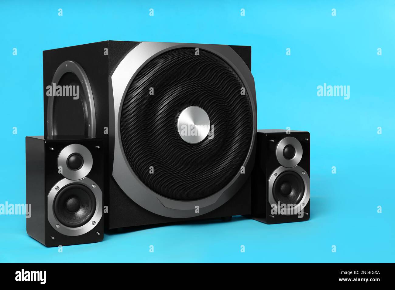 Modern powerful audio speaker system on light blue background Stock ...