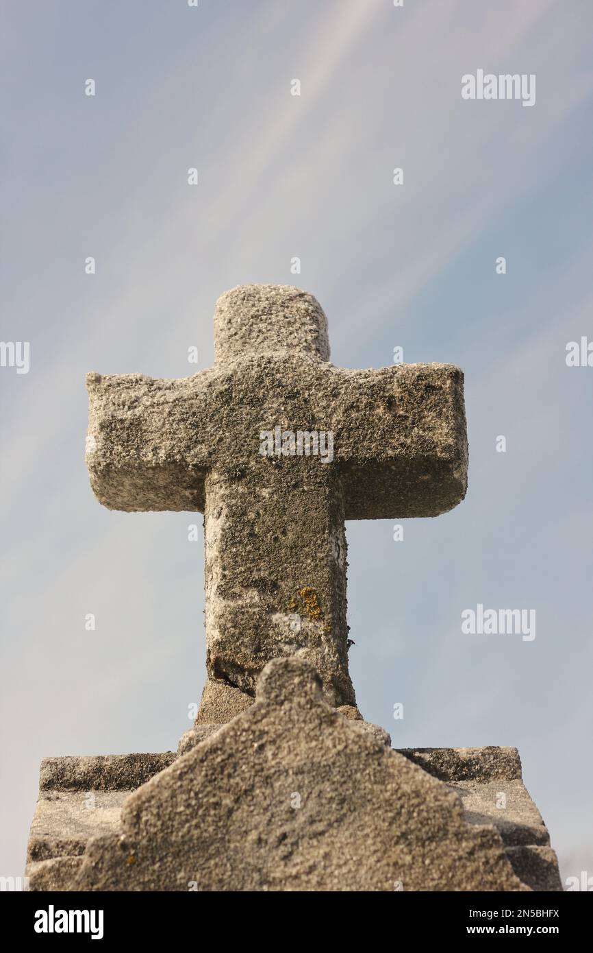 Simple vintage Christian cross standing high on a tombstone in the ...