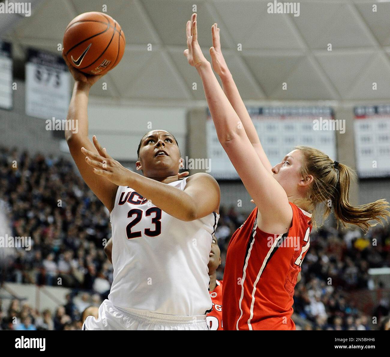 Connecticut's Kaleena Mosqueda-Lewis shoots as Rutgers' Christa Evans ...