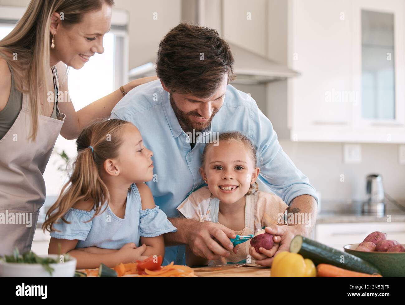 Children and parents cooking in kitchen with vegetables for healthy ...